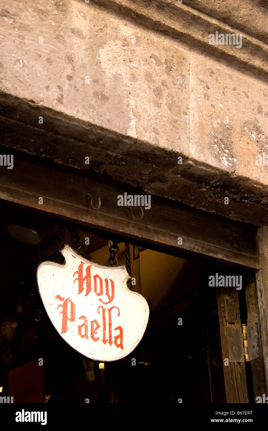 Sign in restaurant doorway indicating that paella is available today in ...