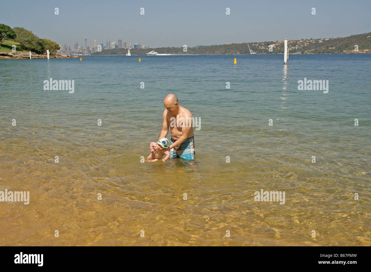 Happy Father holding baby boy in clear ocean, Sydney Australia Stock ...