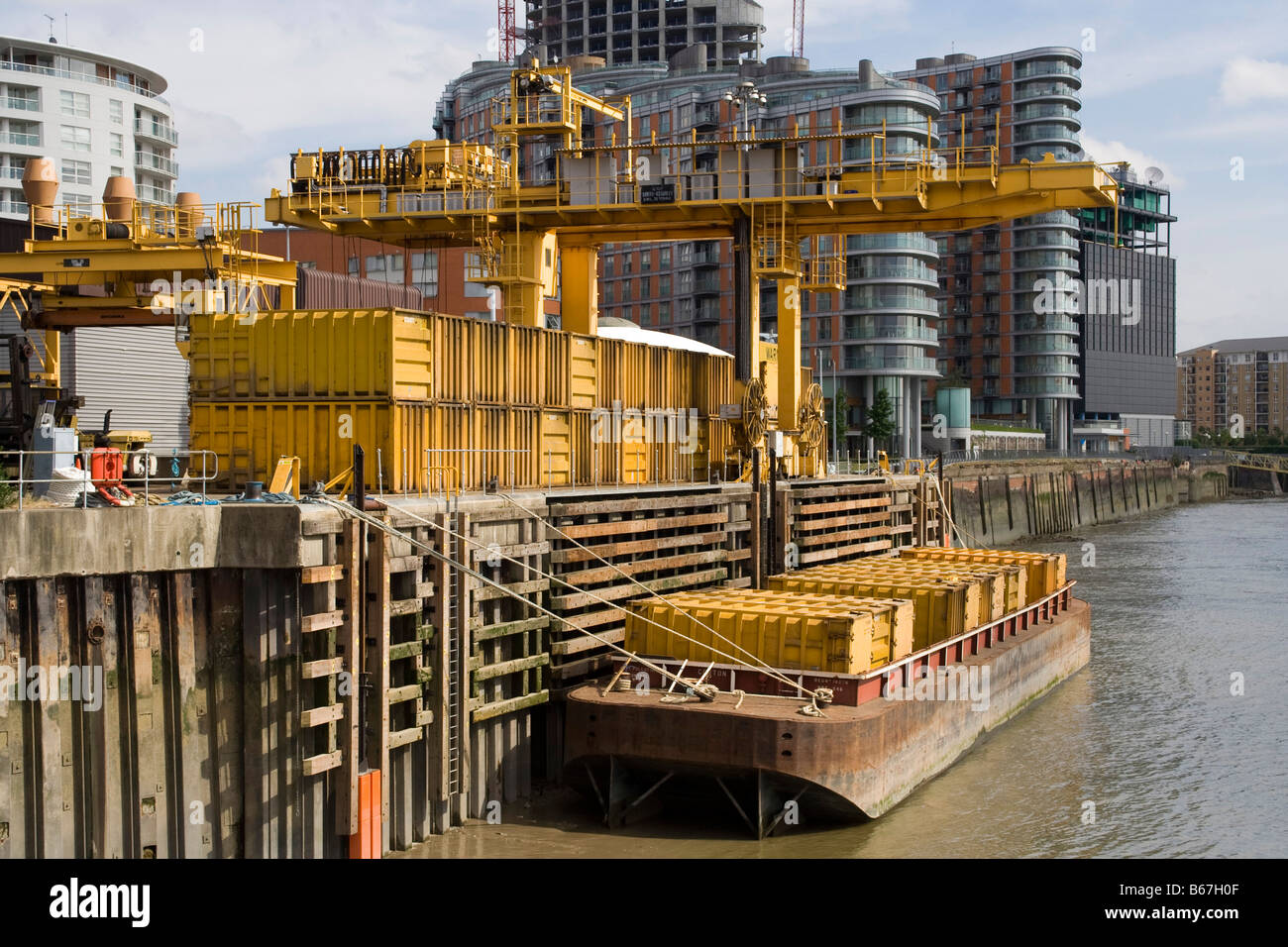 loading containers onto barge river thames canary wharf london england ...