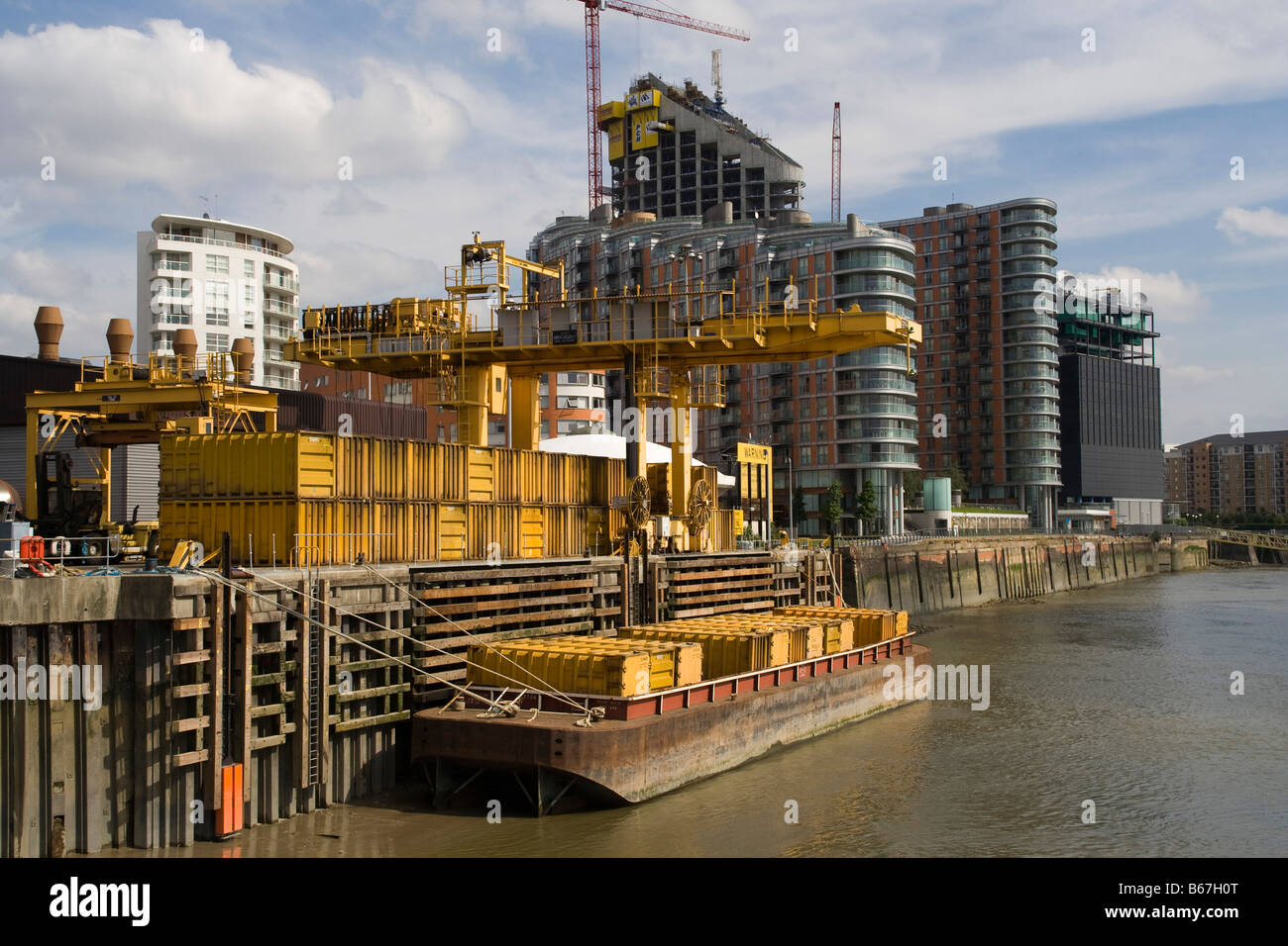 loading containers onto barge river thames canary wharf london england ...