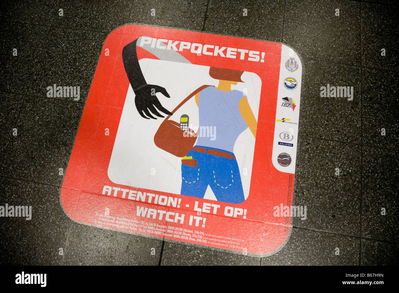 Sign warning about pickpockets on the floor at Brussels station Stock ...