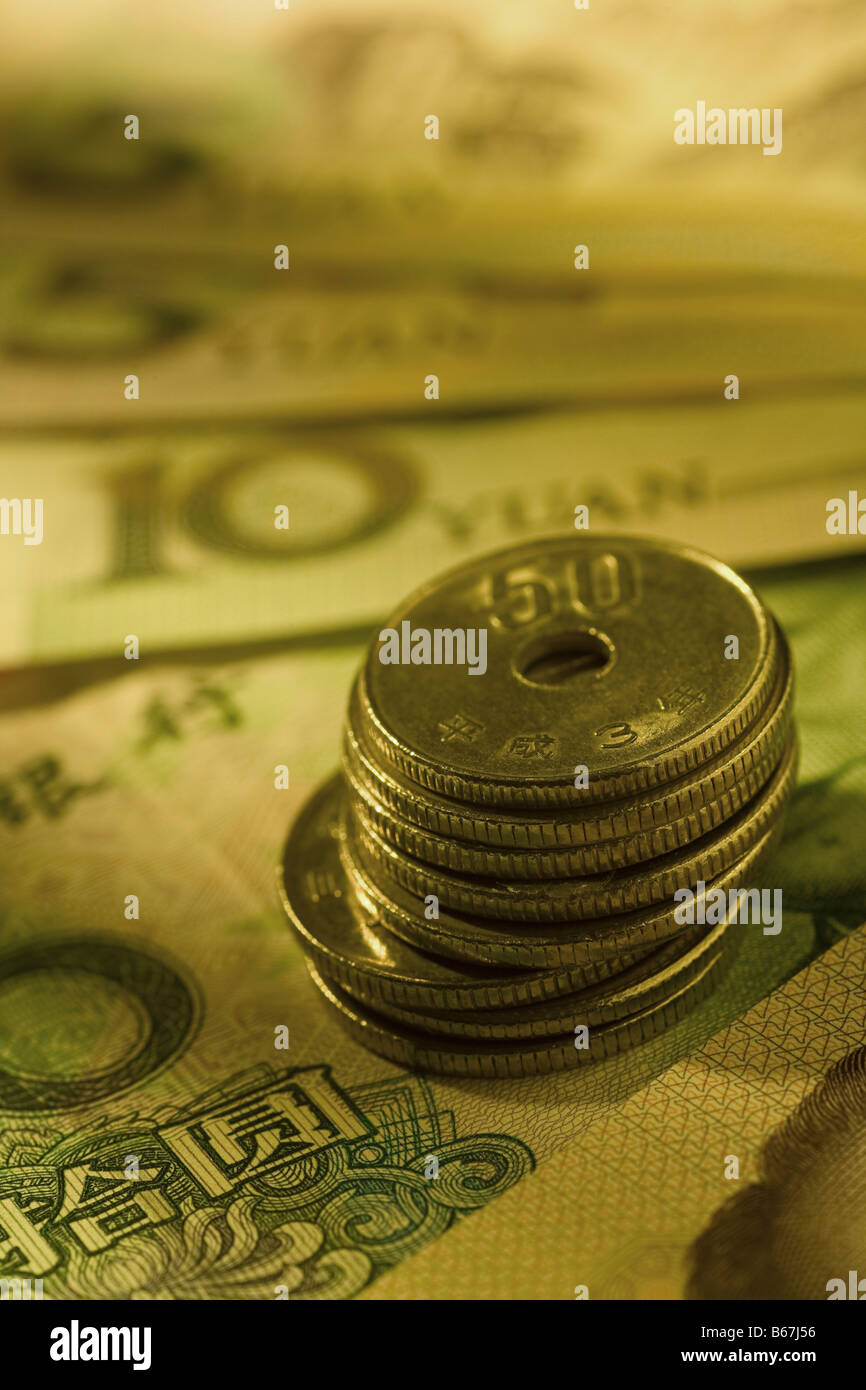 Close-up of a stack of Chinese coins on paper currency Stock Photo - Alamy