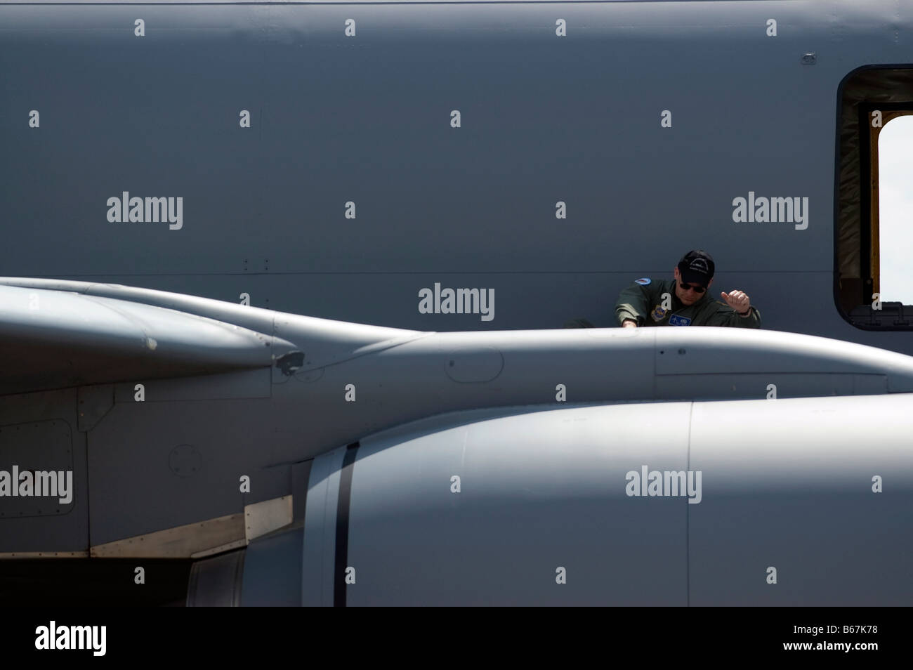 Man resting on the wing of an aircraft Stock Photo - Alamy