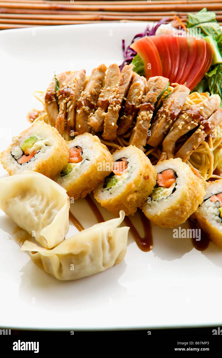 Close-up of sushi with Chinese dumplings served in a tray Stock Photo ...