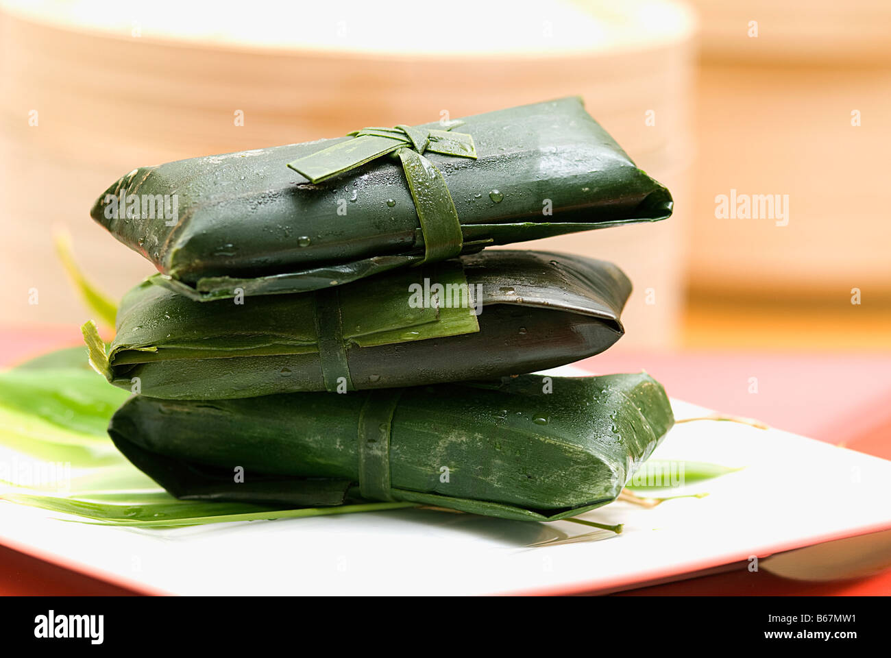 Rice dumplings wrapped in banana leaves Stock Photo - Alamy