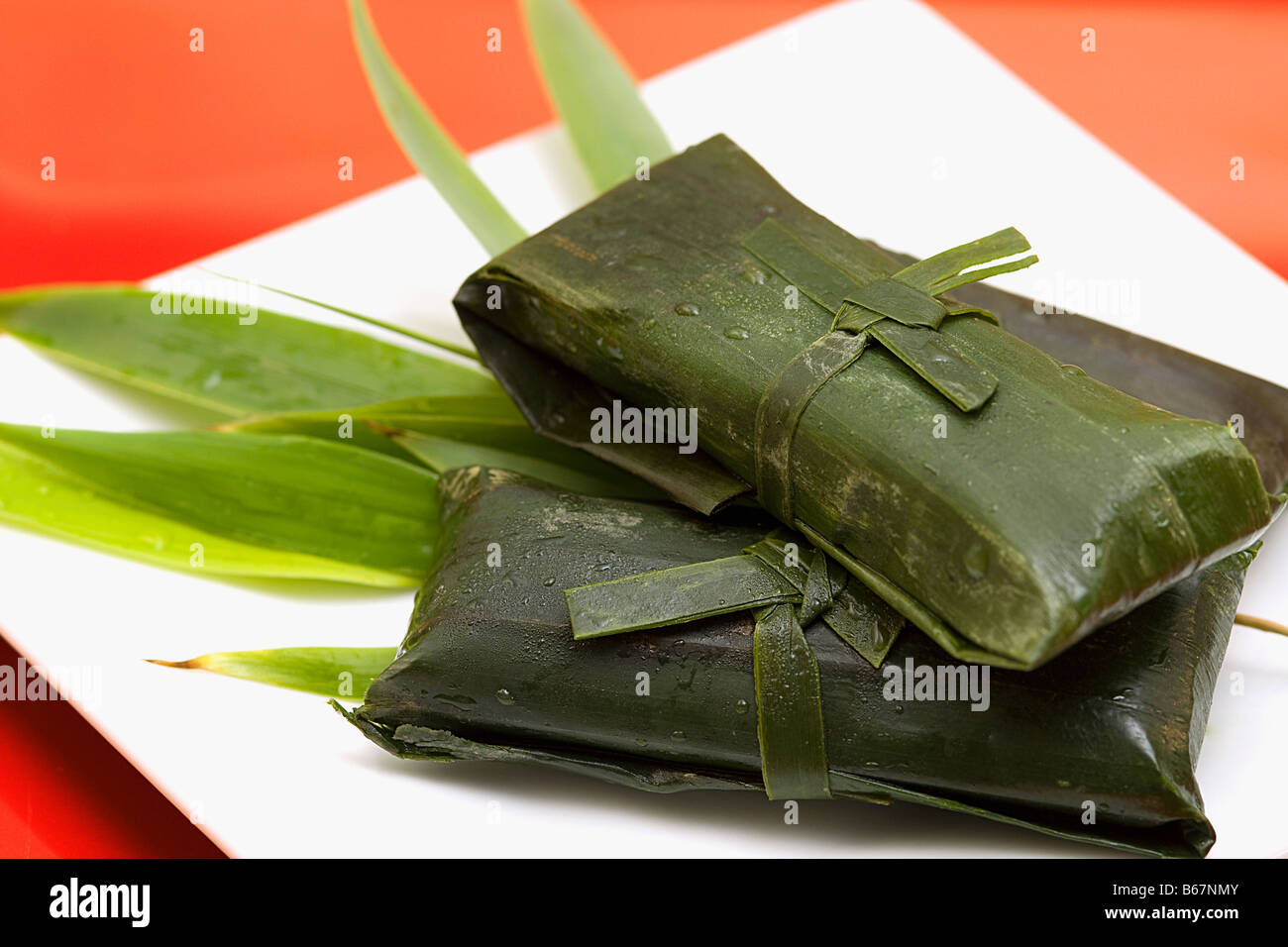 Rice dumplings wrapped in banana leaves Stock Photo - Alamy