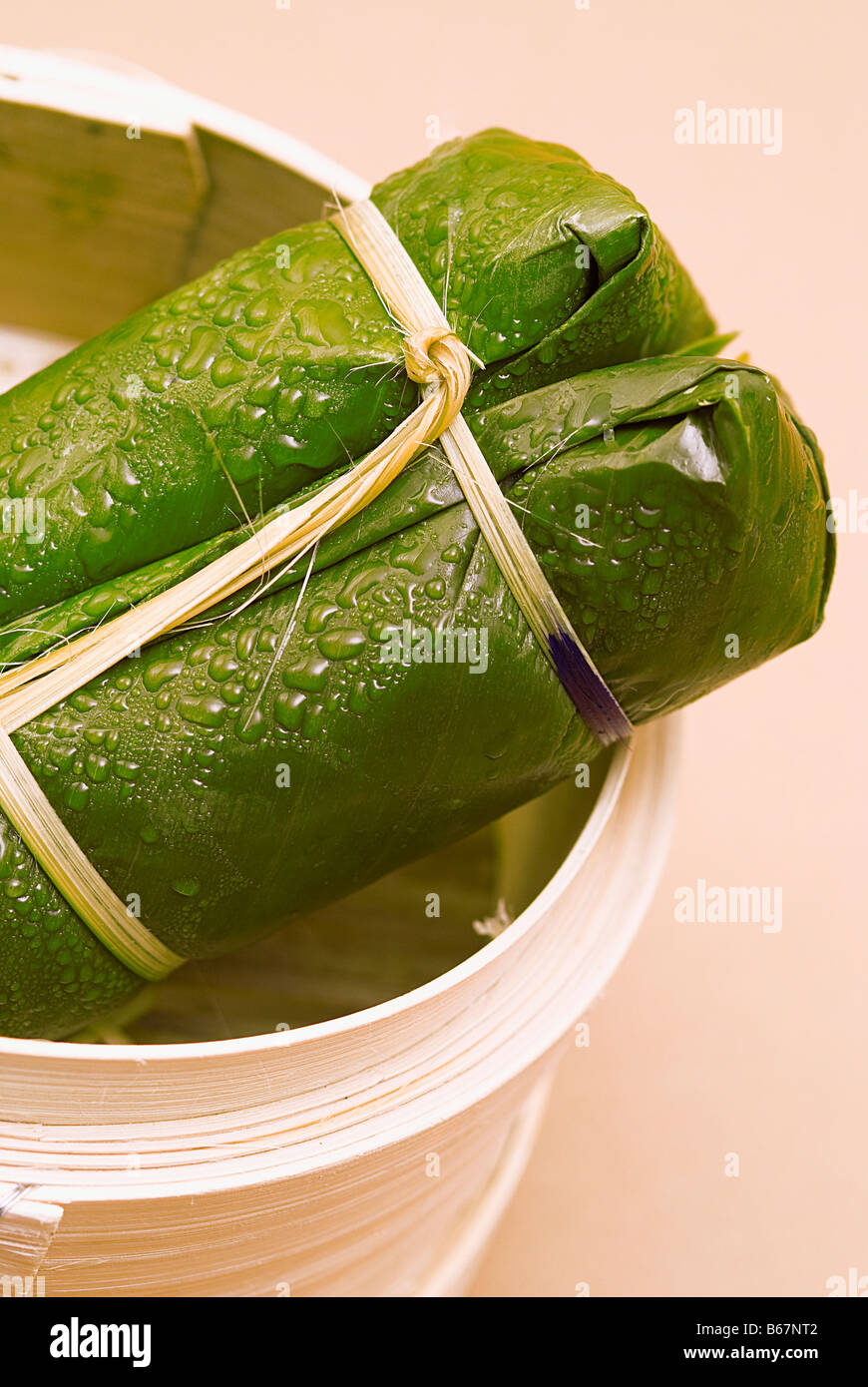 Rice dumpling wrapped in banana leaf Stock Photo - Alamy