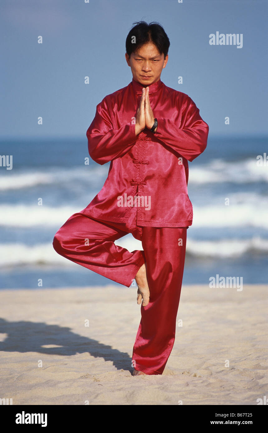 Man doing Tai Chi exercises on the beach, China Beach and Sea, Harmony ...