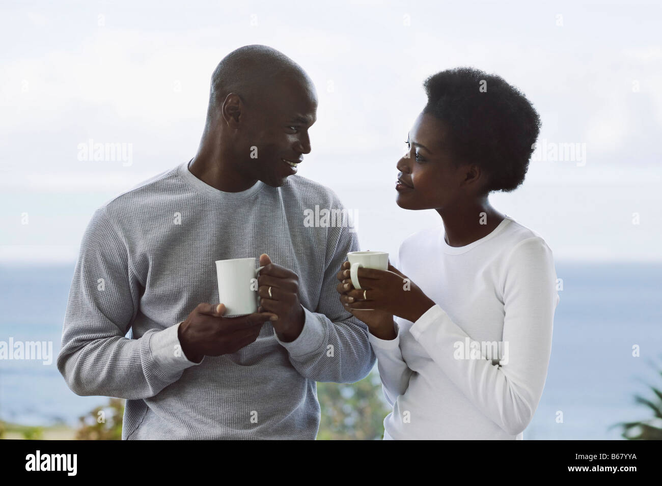 Couple Drinking Coffee on Balcony Stock Photo - Alamy