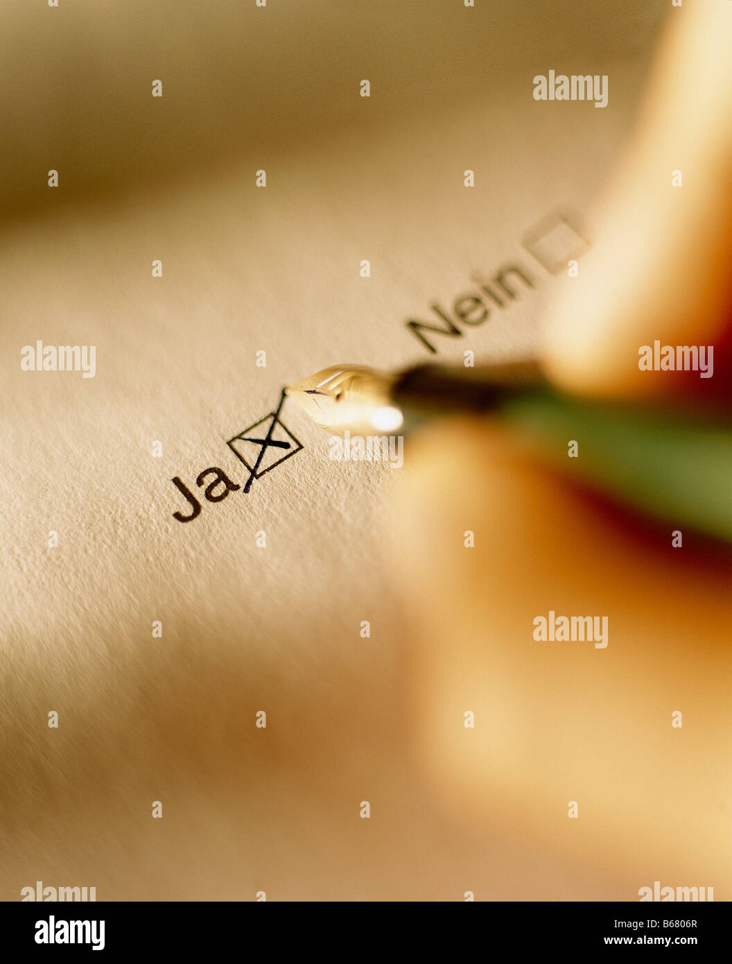 Hand with pen marking yes on form Stock Photo - Alamy