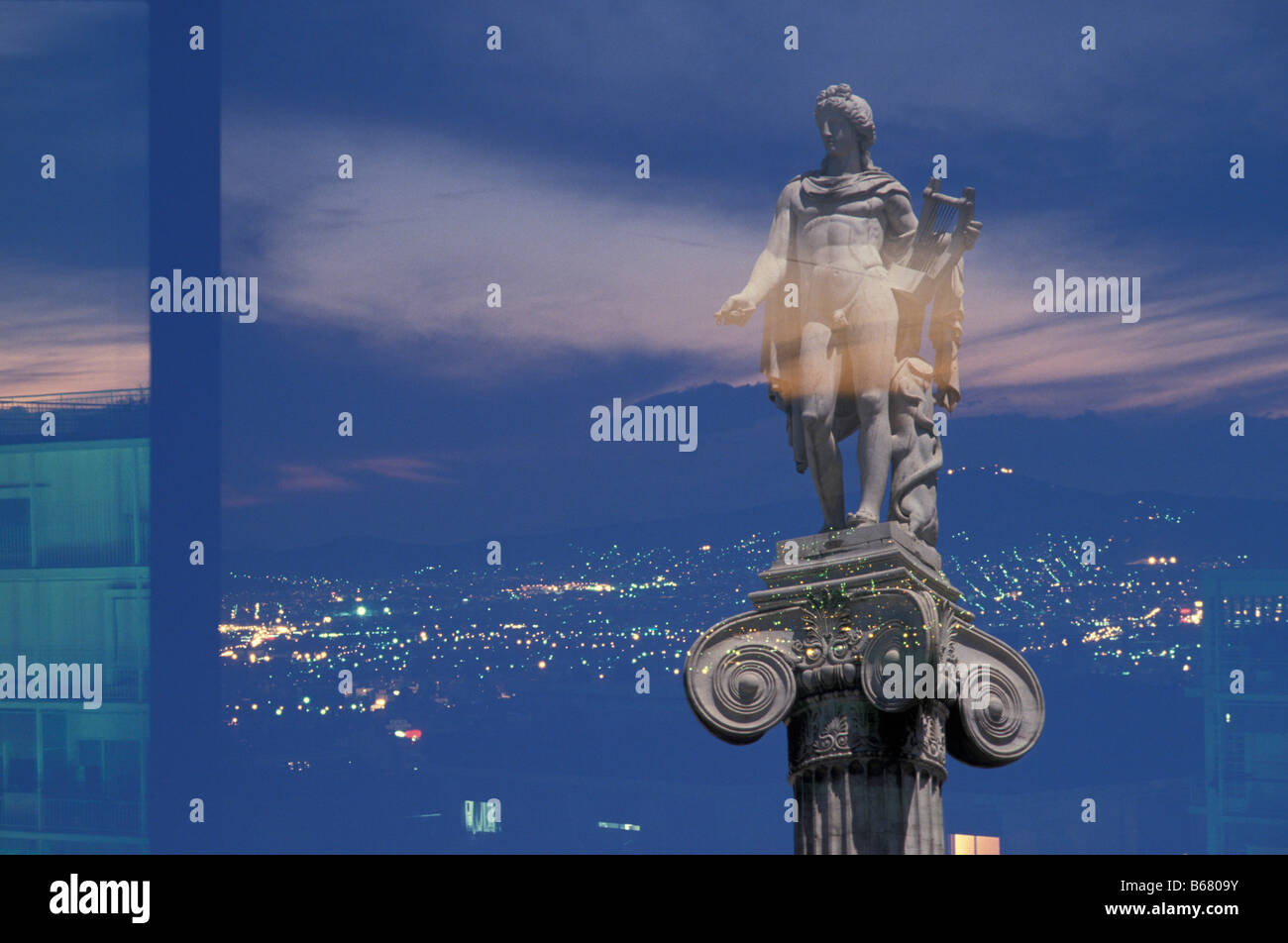 Statue on capital with cityscape, Athens, Greece Stock Photo - Alamy
