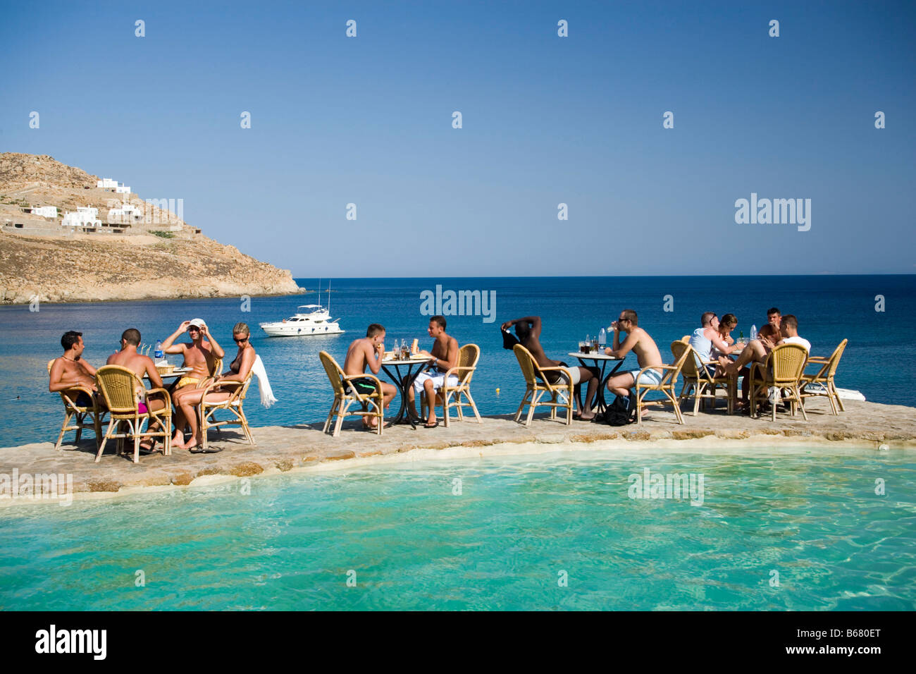 People sitting in the Coco Club at Super Paradise Beach, Psarou ...