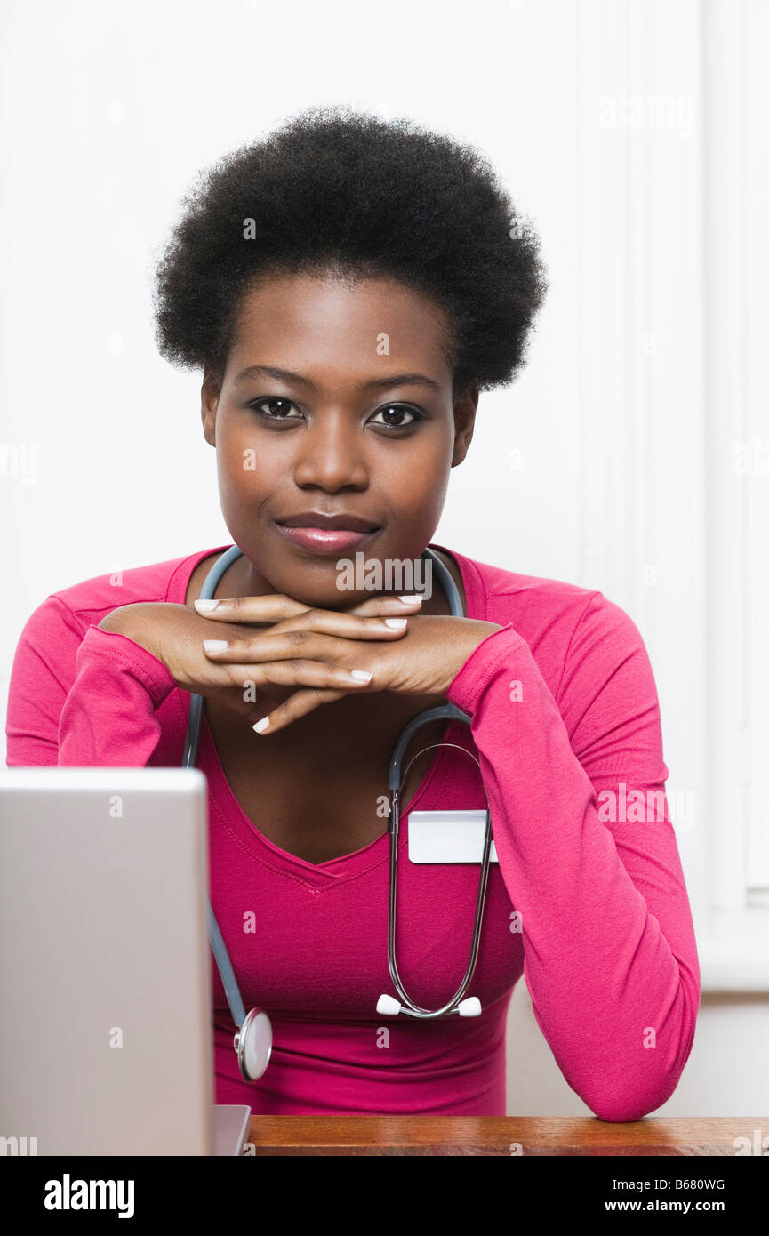 Physician Sitting Behind Desk Stock Photo - Alamy
