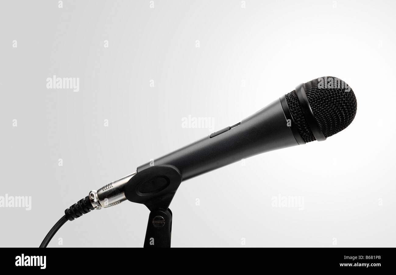 Microphone on stand against light background Stock Photo - Alamy