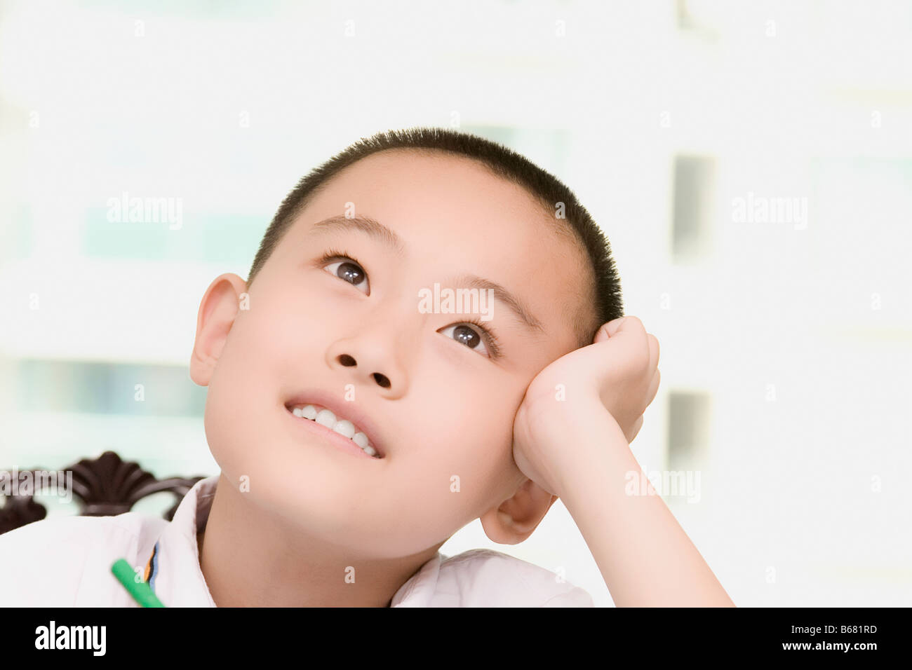 Close-up of a boy thinking and smiling Stock Photo - Alamy