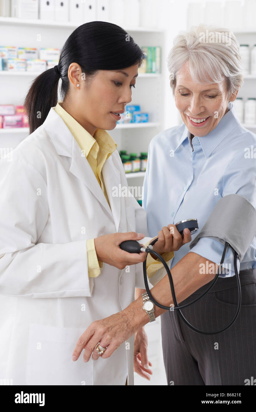 Pharmacist taking blood pressure hi-res stock photography and images ...