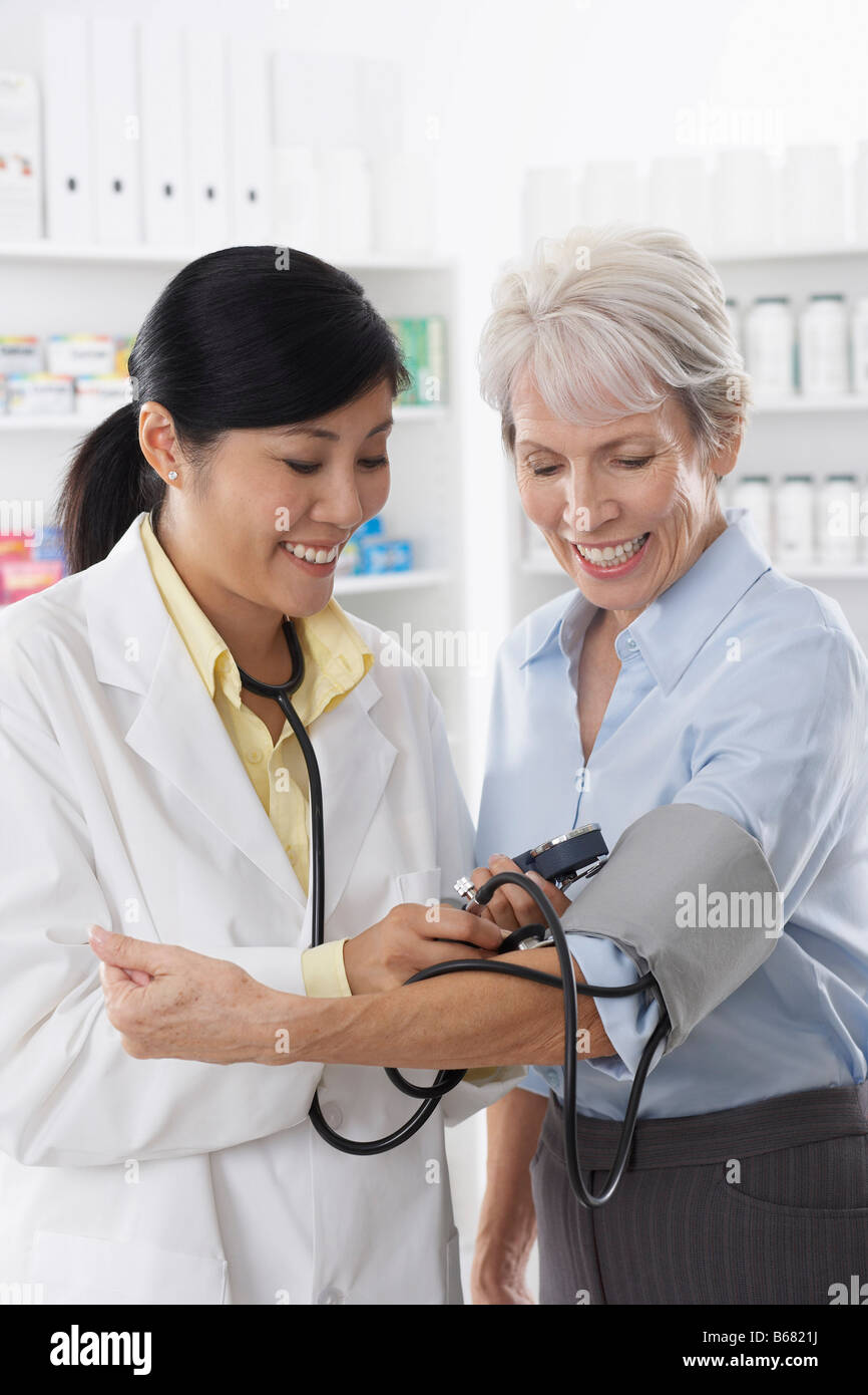 Pharmacist taking blood pressure hi-res stock photography and images ...