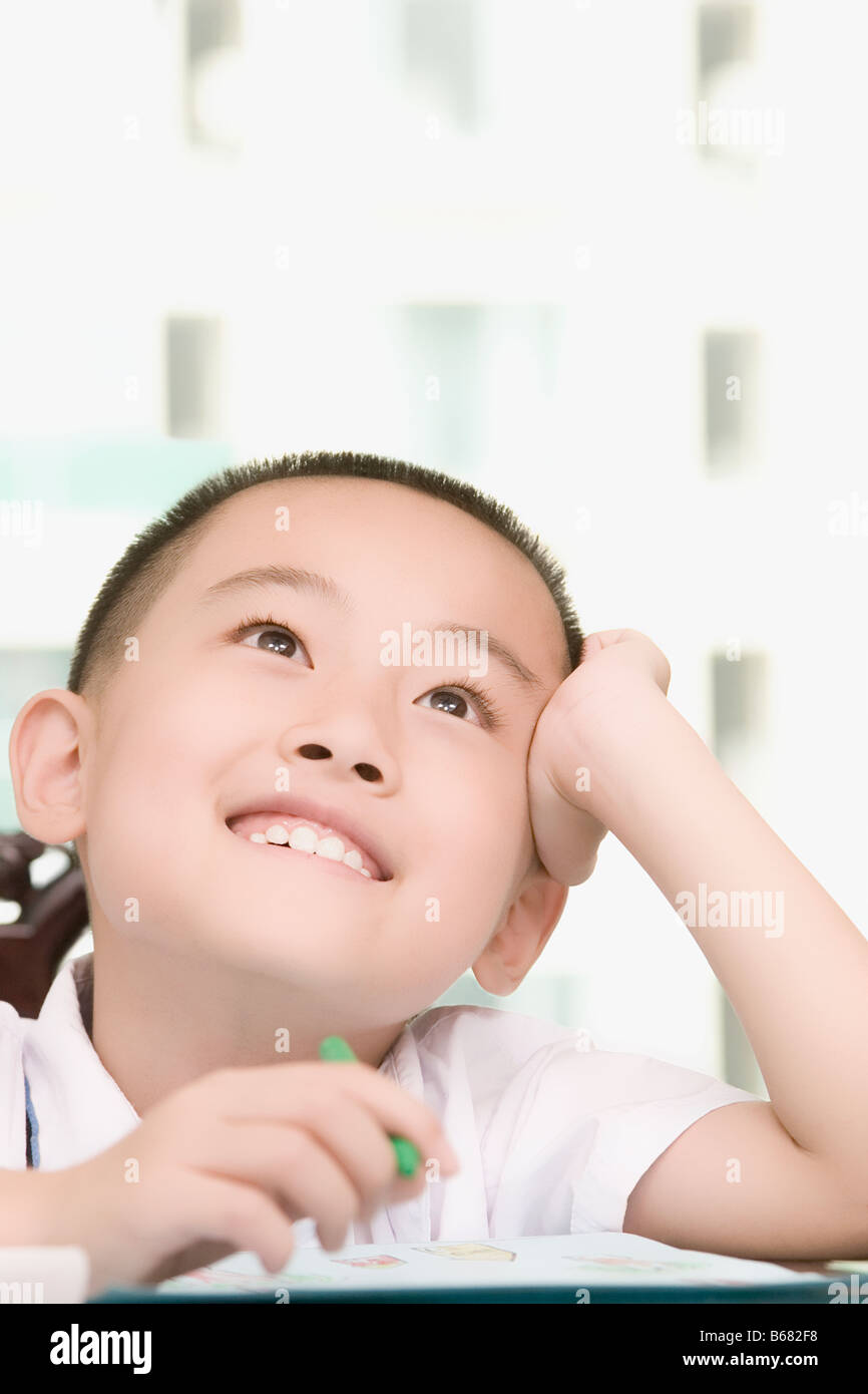 Close-up of a boy thinking and smiling Stock Photo - Alamy
