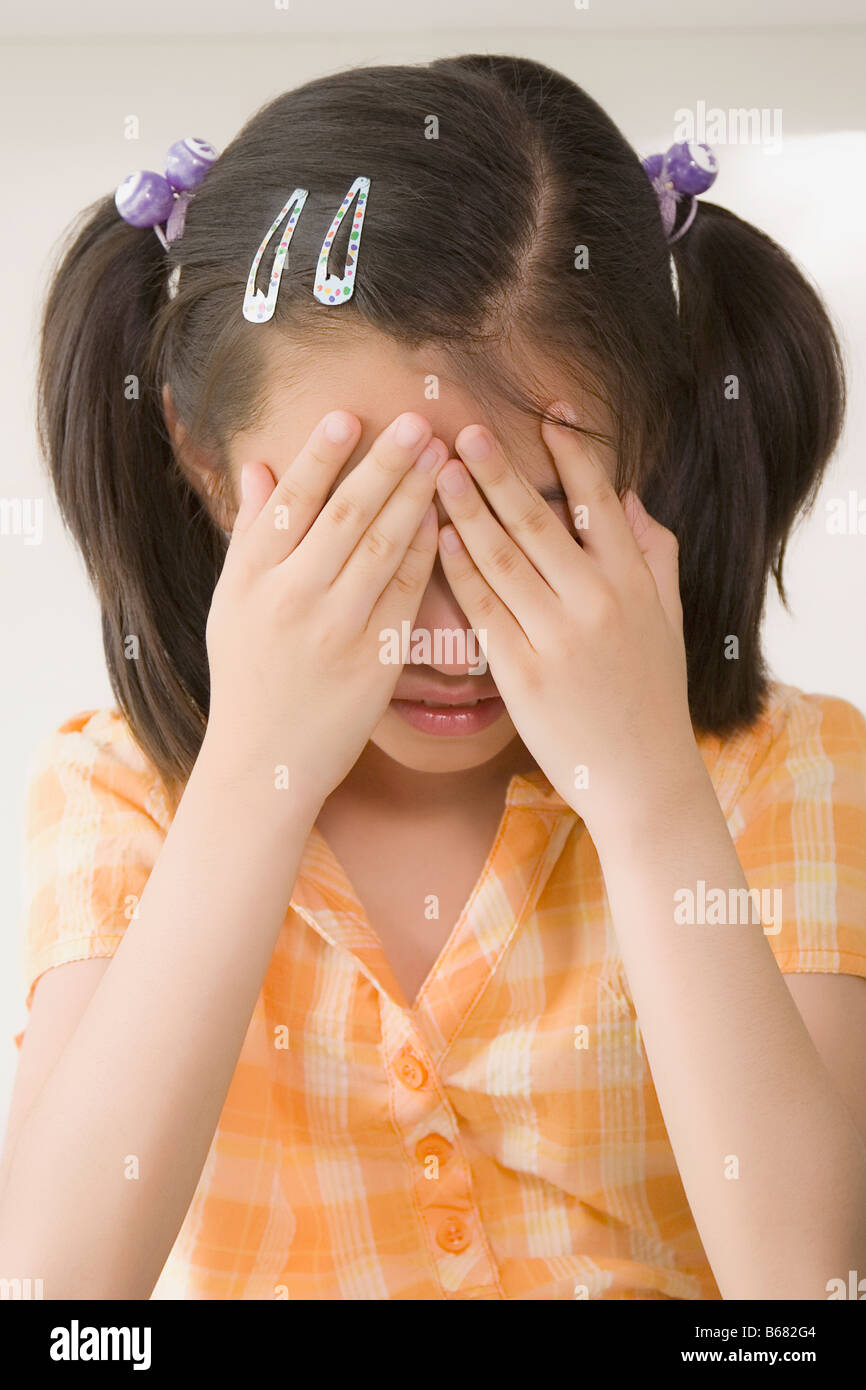 Close-up of a girl crying and hiding her face Stock Photo - Alamy