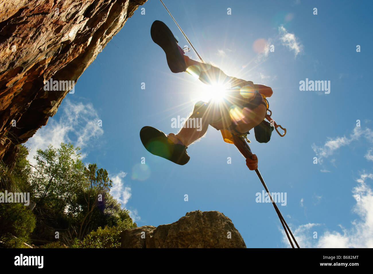 Man descending on abseil rope Stock Photo - Alamy