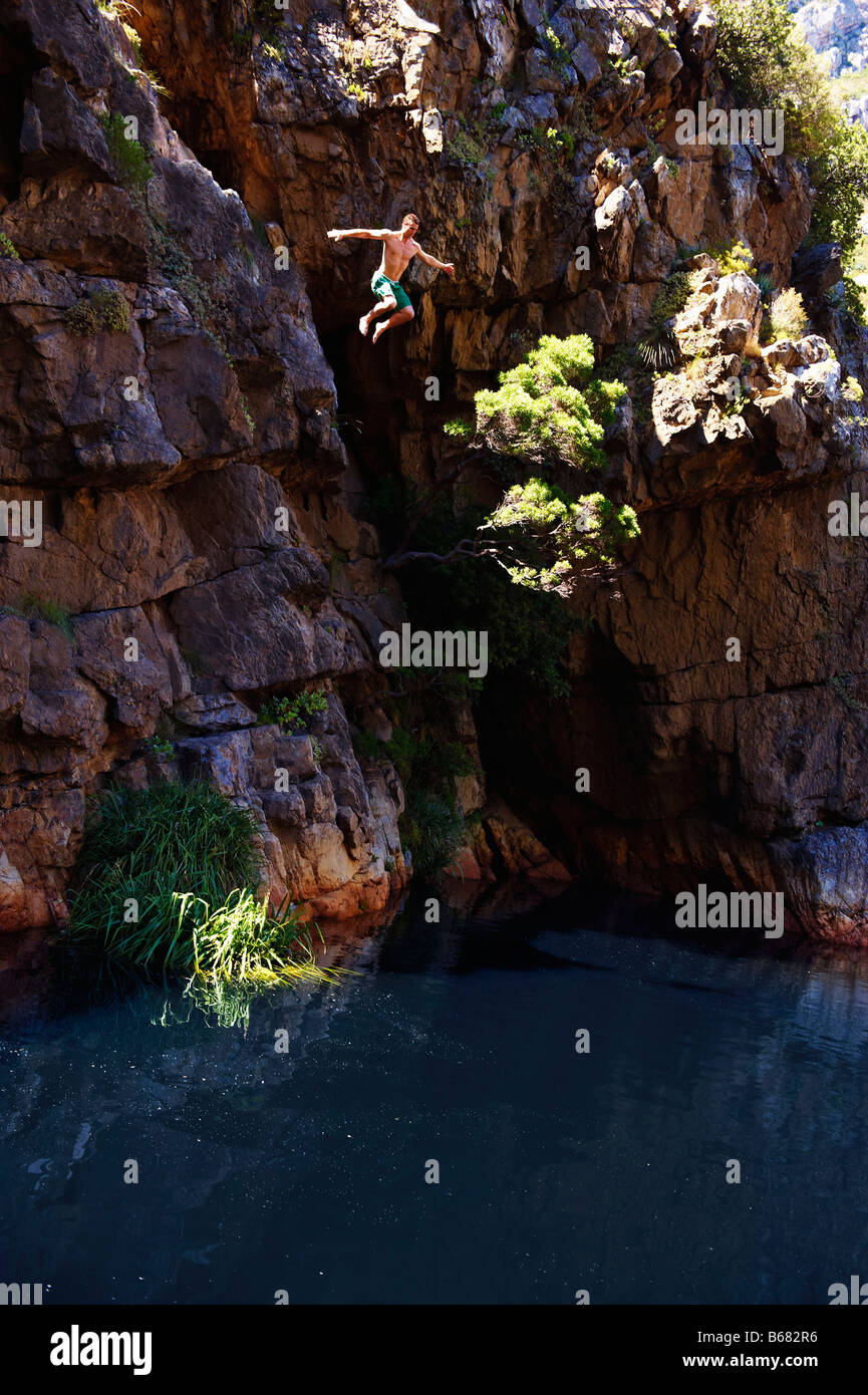 Man cliff jumping into pool Stock Photo - Alamy