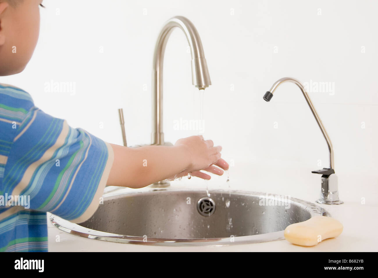 Side profile of a boy washing his hand Stock Photo - Alamy