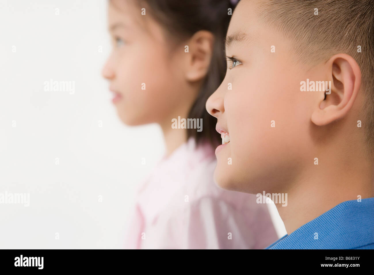 Side profile of a boy smiling with his sister Stock Photo - Alamy
