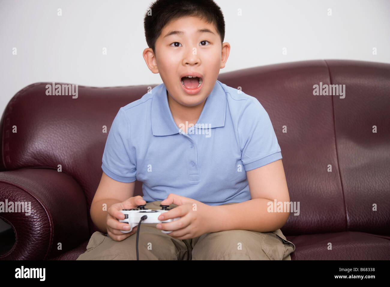 Boy playing video game Stock Photo - Alamy