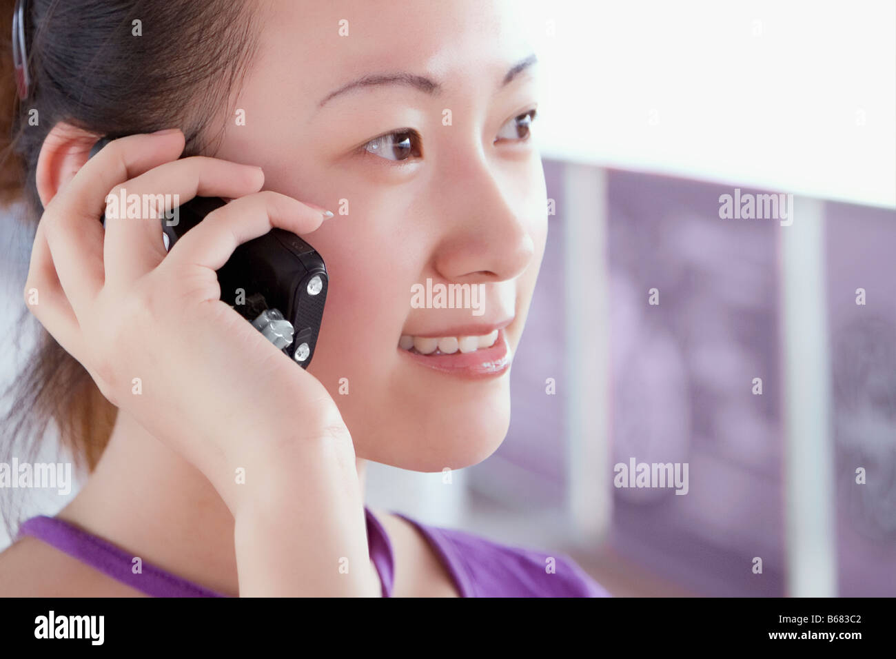 Close-up of a young woman talking on a mobile phone Stock Photo - Alamy