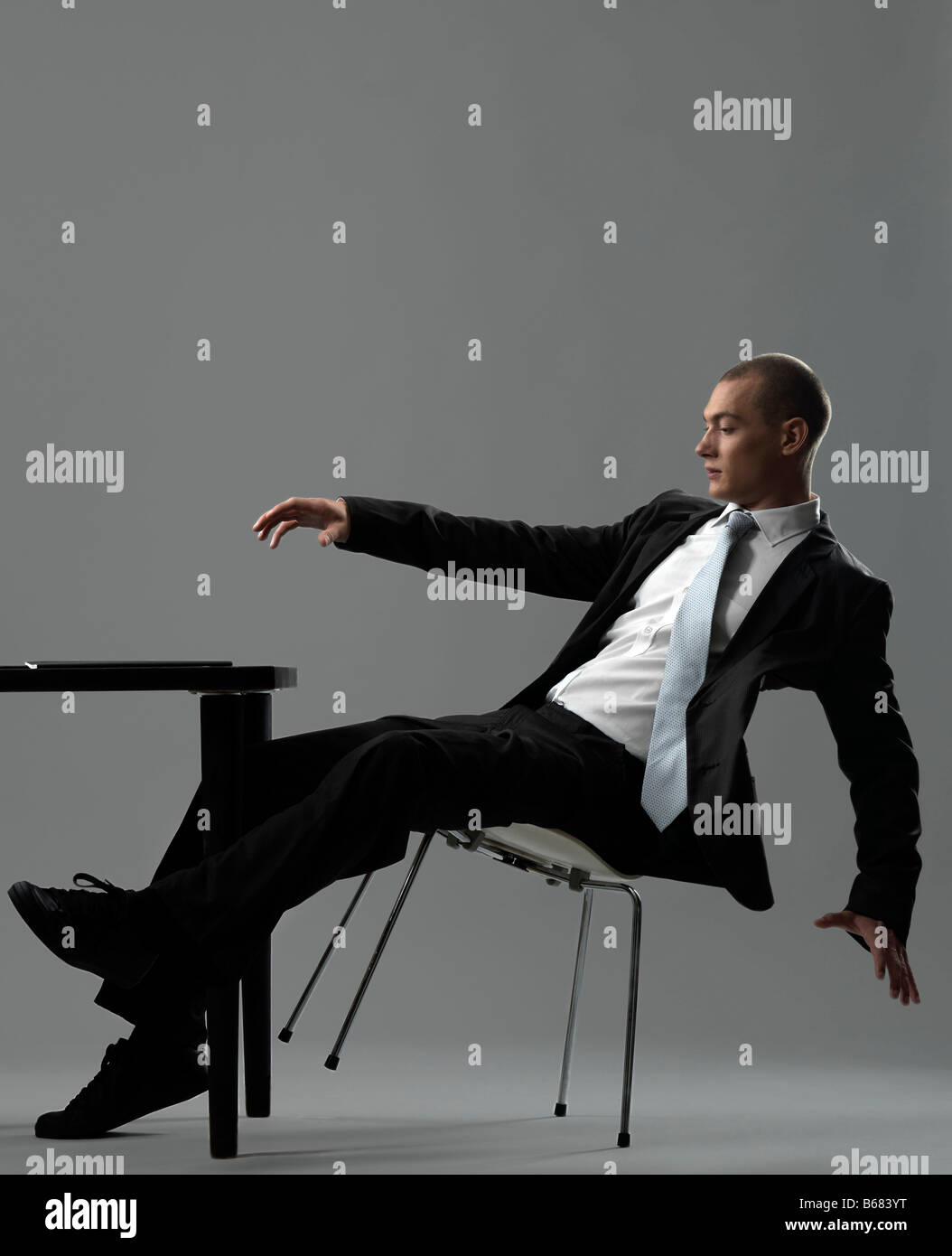 Business man falling from chair Stock Photo - Alamy