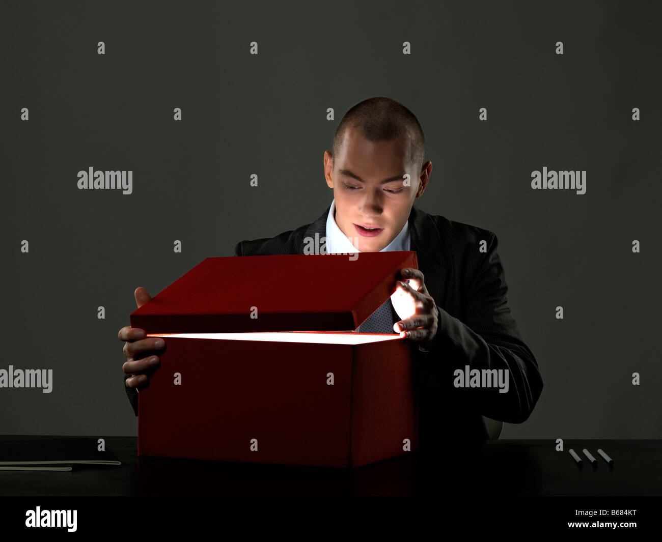Business man opening box Stock Photo - Alamy
