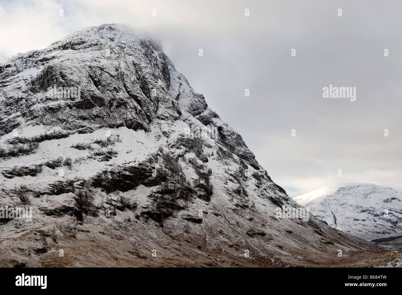 Blue sky, snow covered mountains and morning clouds covering the ...