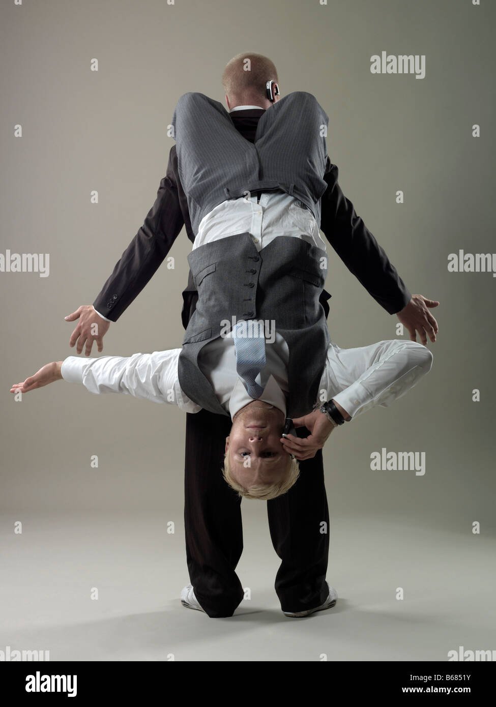 Business men balancing Stock Photo - Alamy