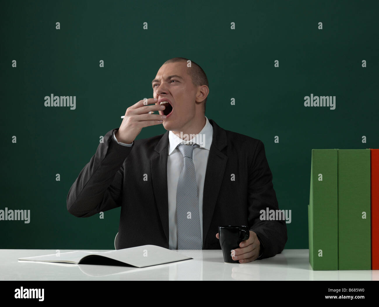 Business man yawning Stock Photo - Alamy