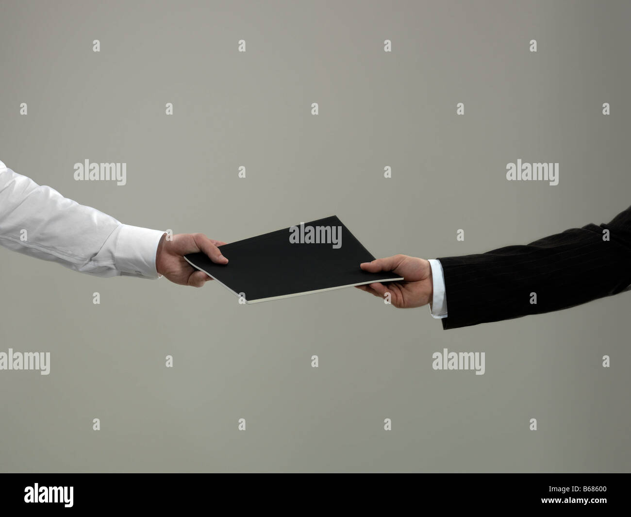 Business man handing folder to colleague Stock Photo - Alamy