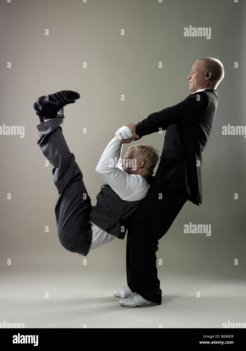 Business men balancing Stock Photo - Alamy