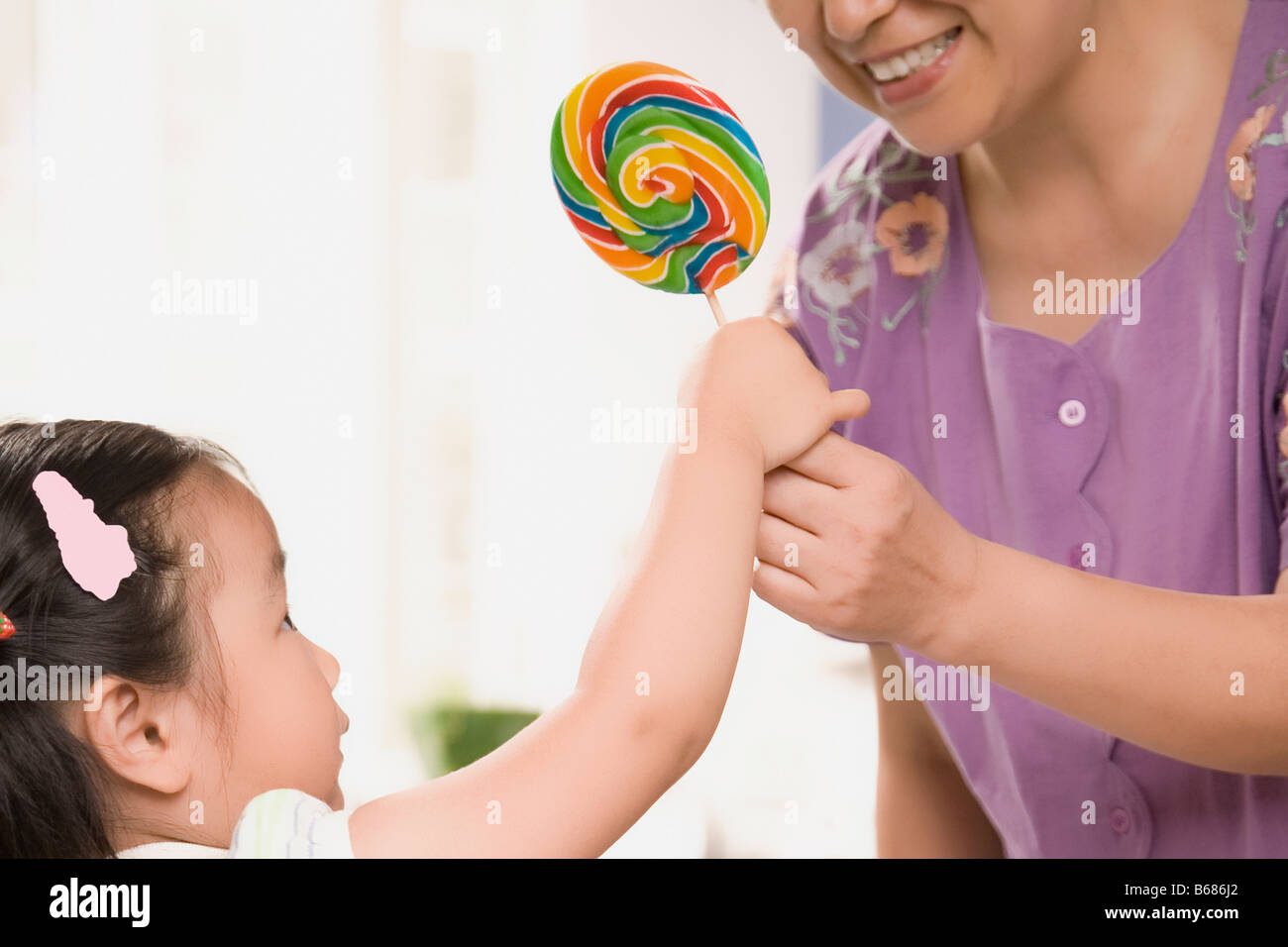 Woman giving candy to children hi-res stock photography and images - Alamy