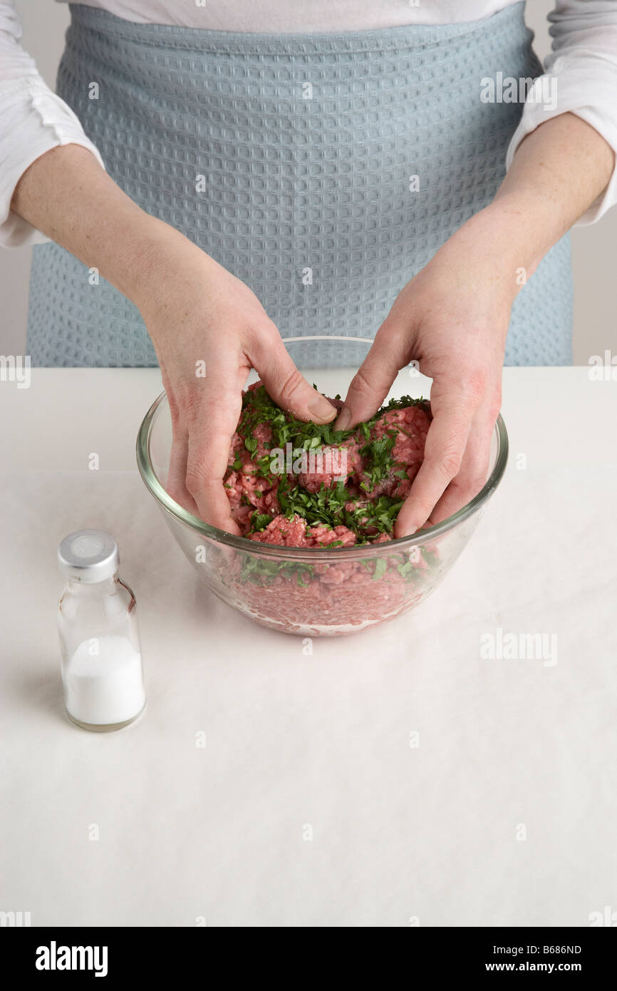 Woman Mixing Beef and Ingredients to Make Hamburgers Stock Photo - Alamy