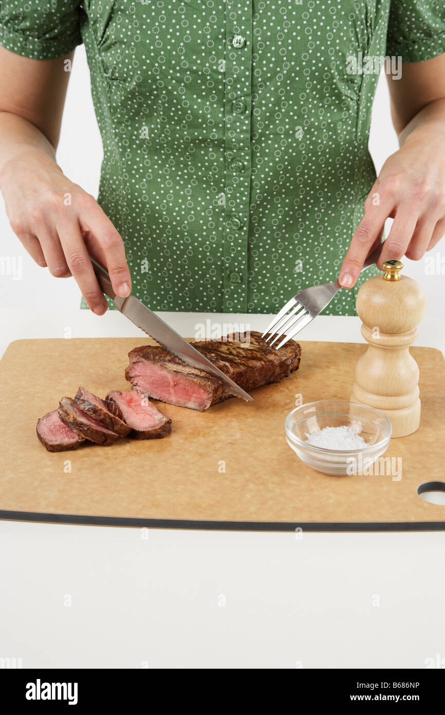 Woman Eating Steak Stock Photo - Alamy