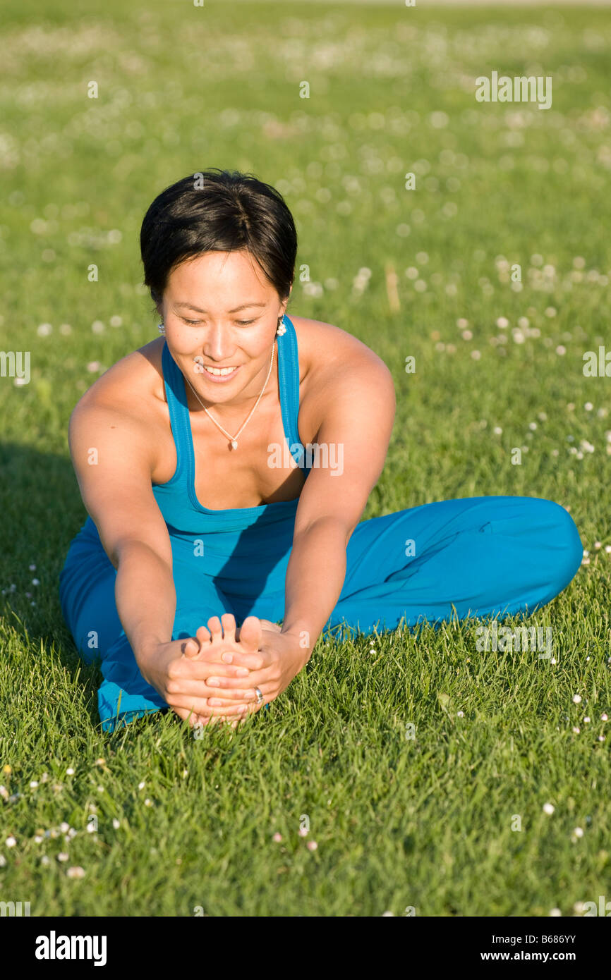 Woman sitting stretched out on grass hi-res stock photography and ...