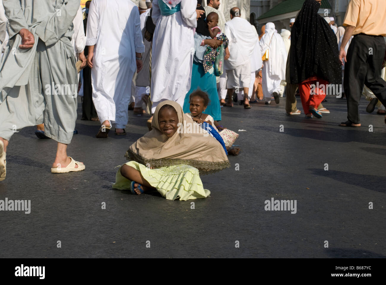 Two little girls sitting on the street begging pilgrims for money ...