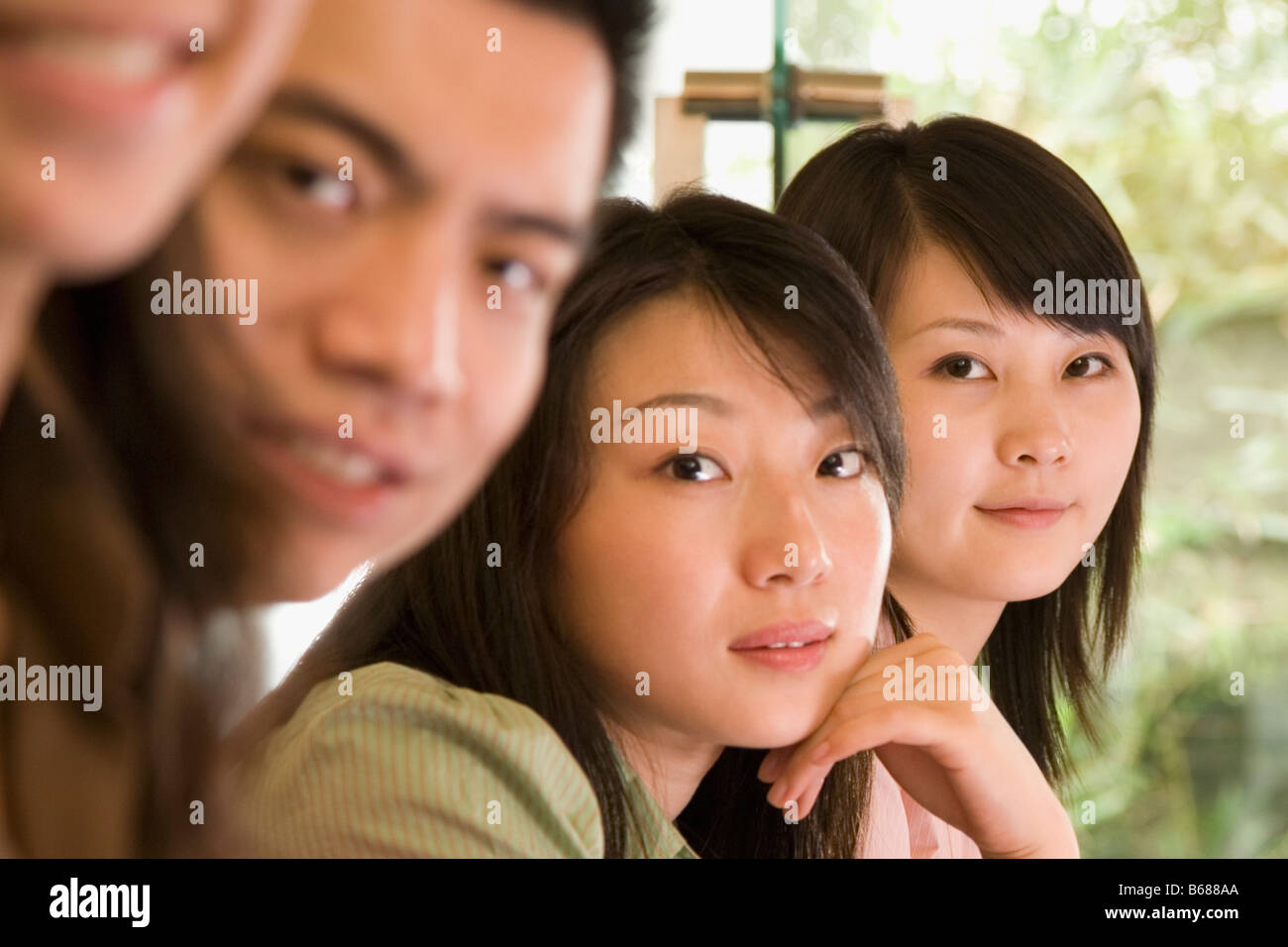 Portrait of office workers sitting side by side Stock Photo - Alamy