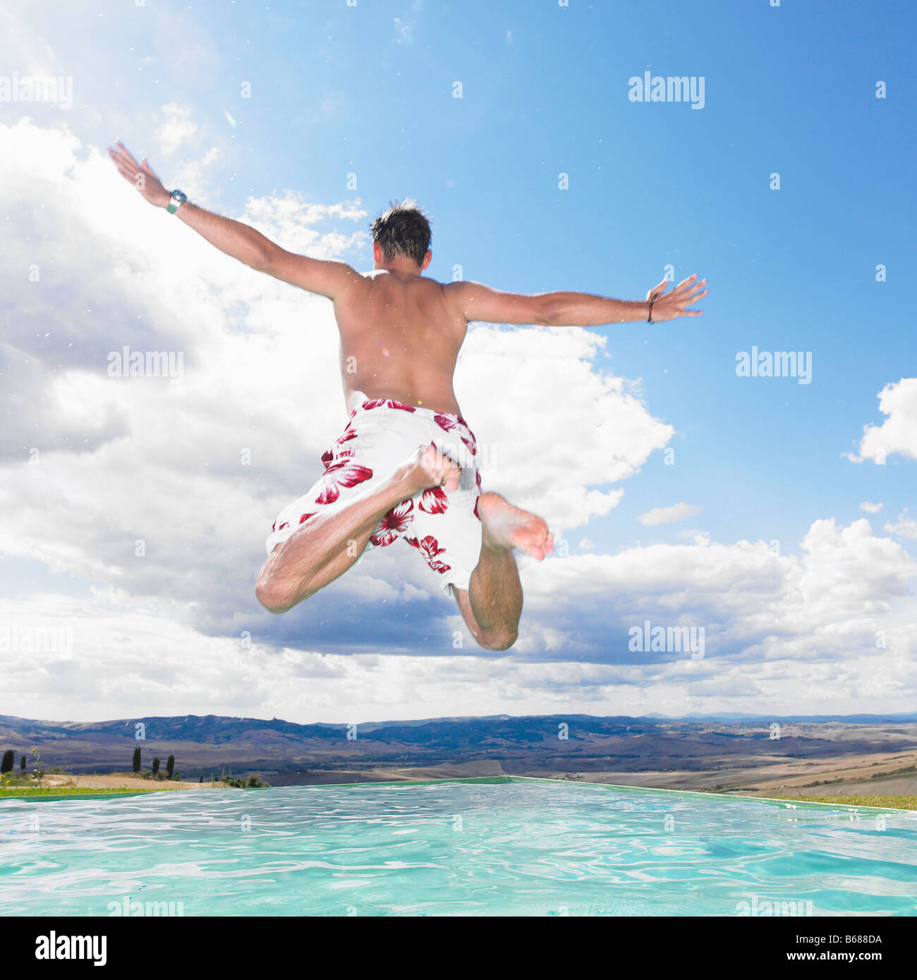 Man jumping in swimming pool Stock Photo - Alamy