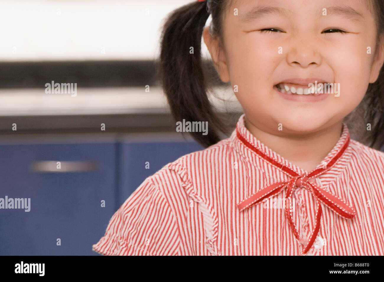 Close-up of a girl smiling and clenching her teeth Stock Photo - Alamy