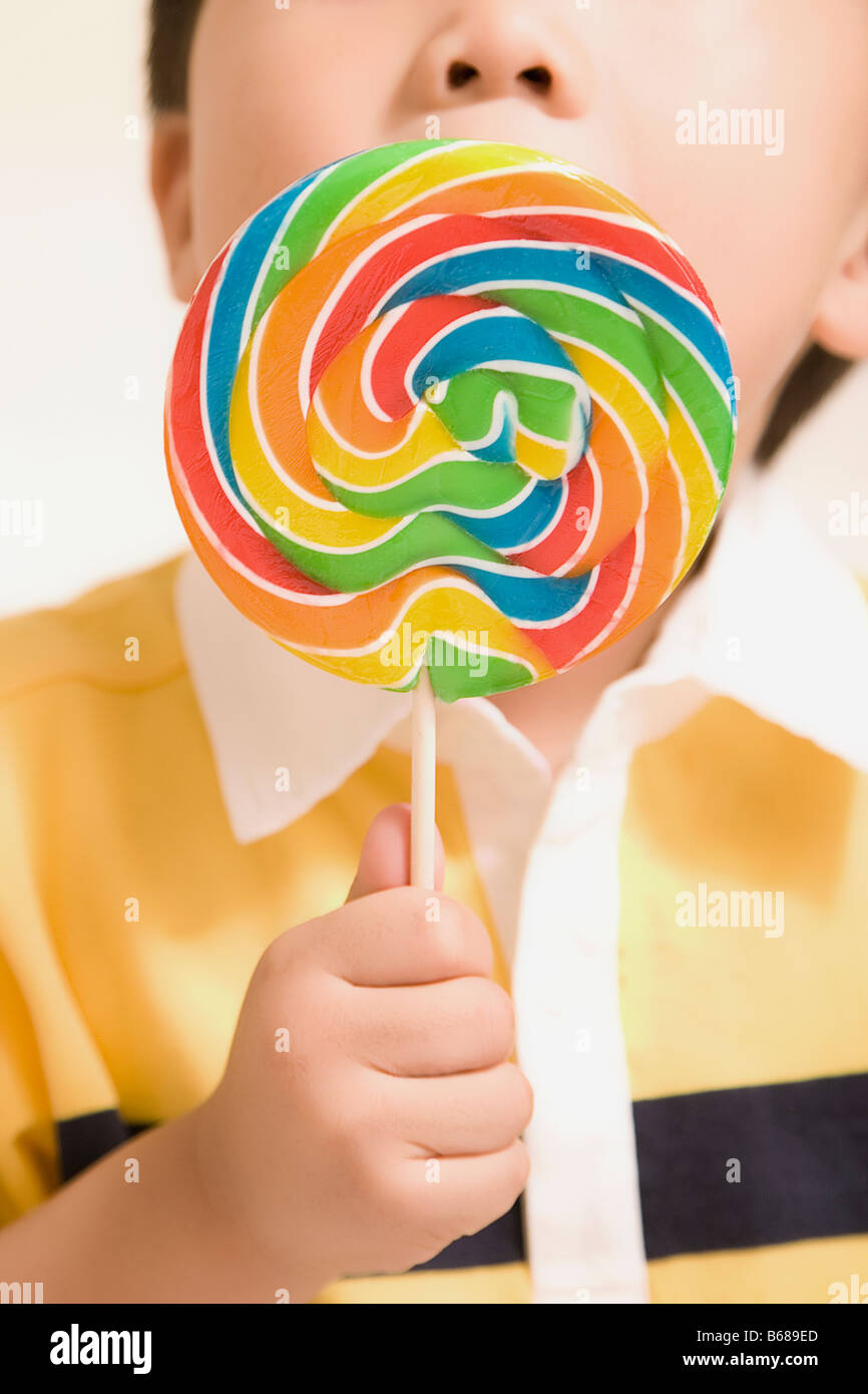 Close-up of a boy eating a lollipop Stock Photo - Alamy