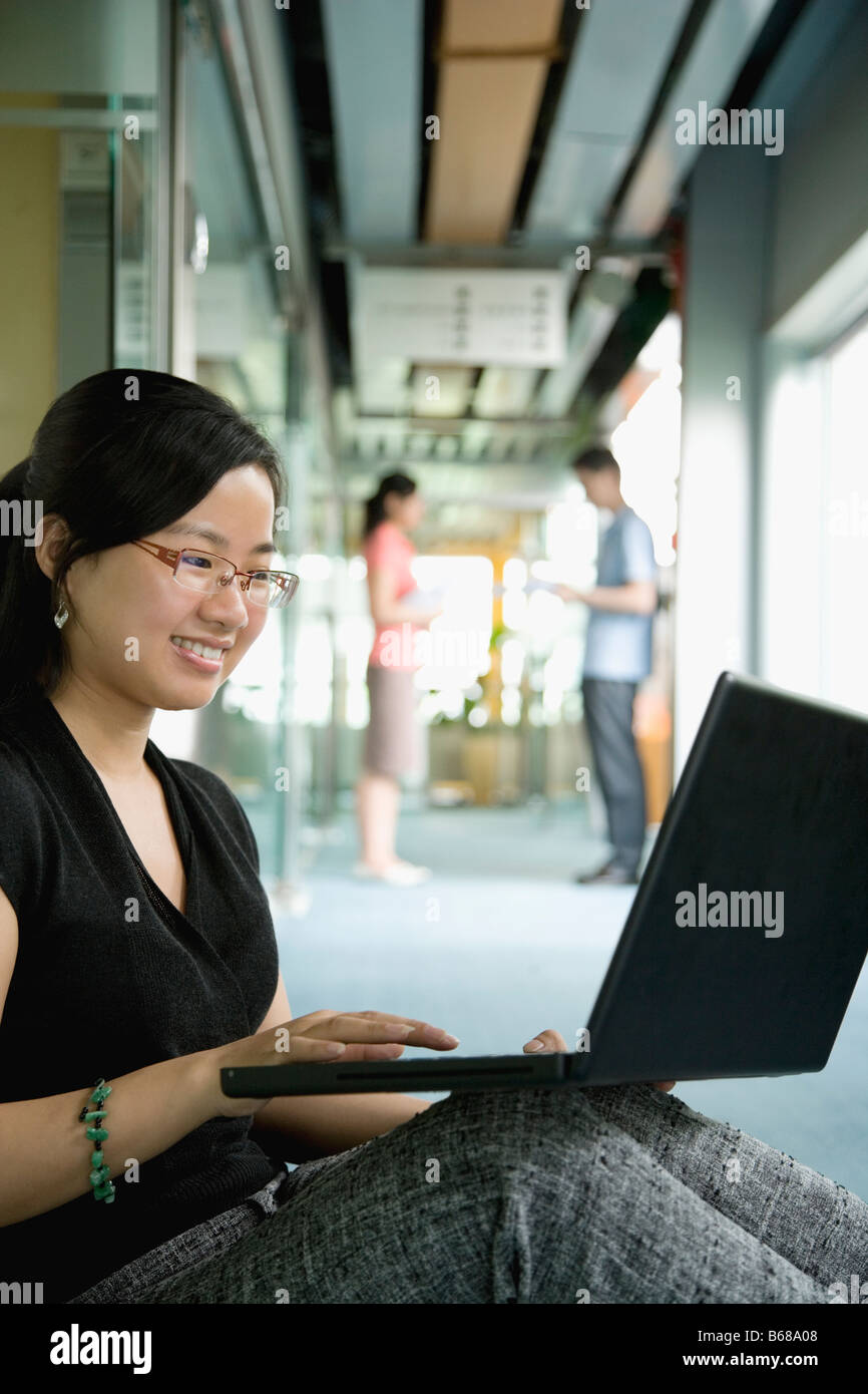 Side profile of a female office worker using a laptop Stock Photo - Alamy