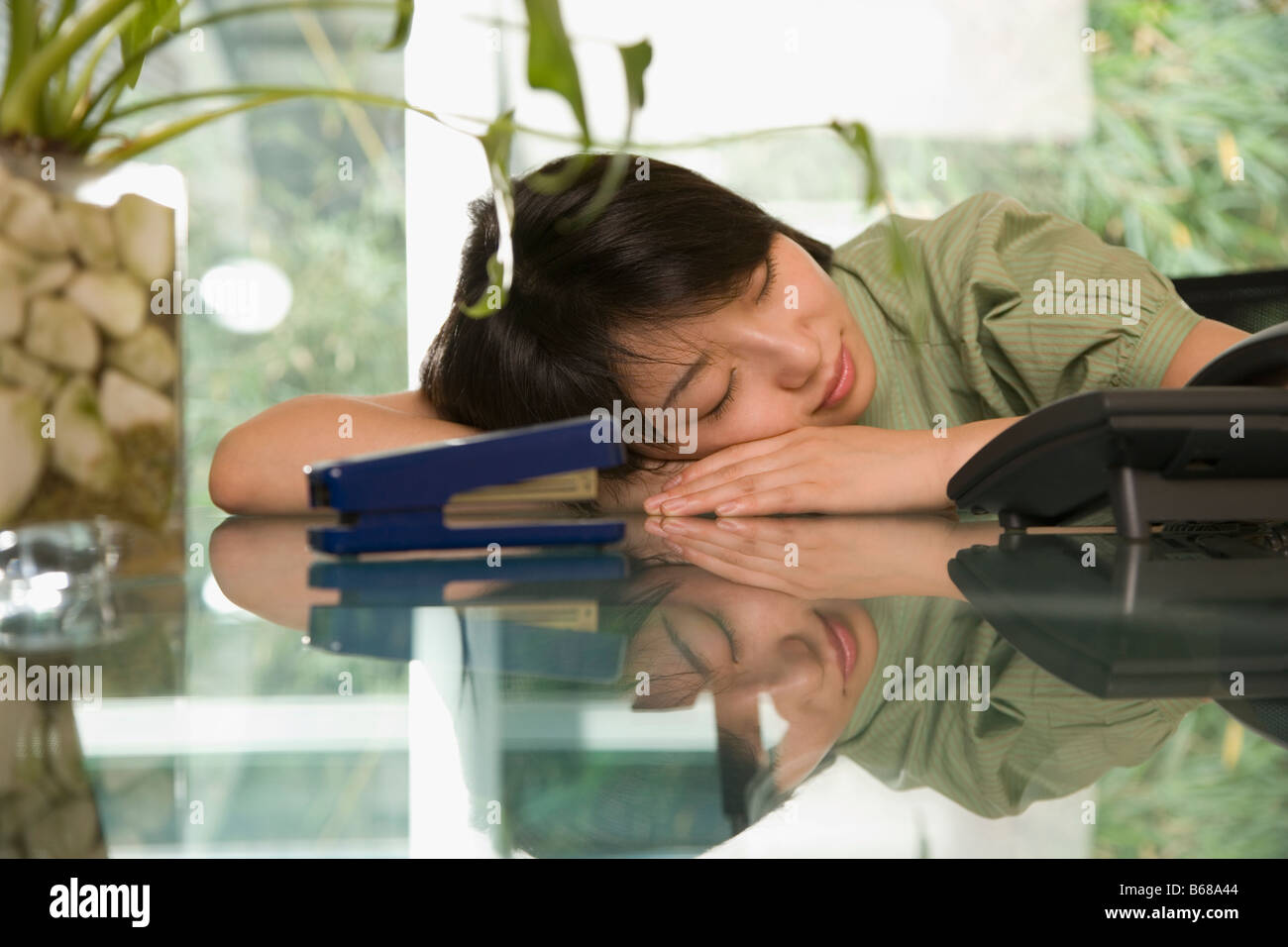 Female office worker napping at a table Stock Photo - Alamy