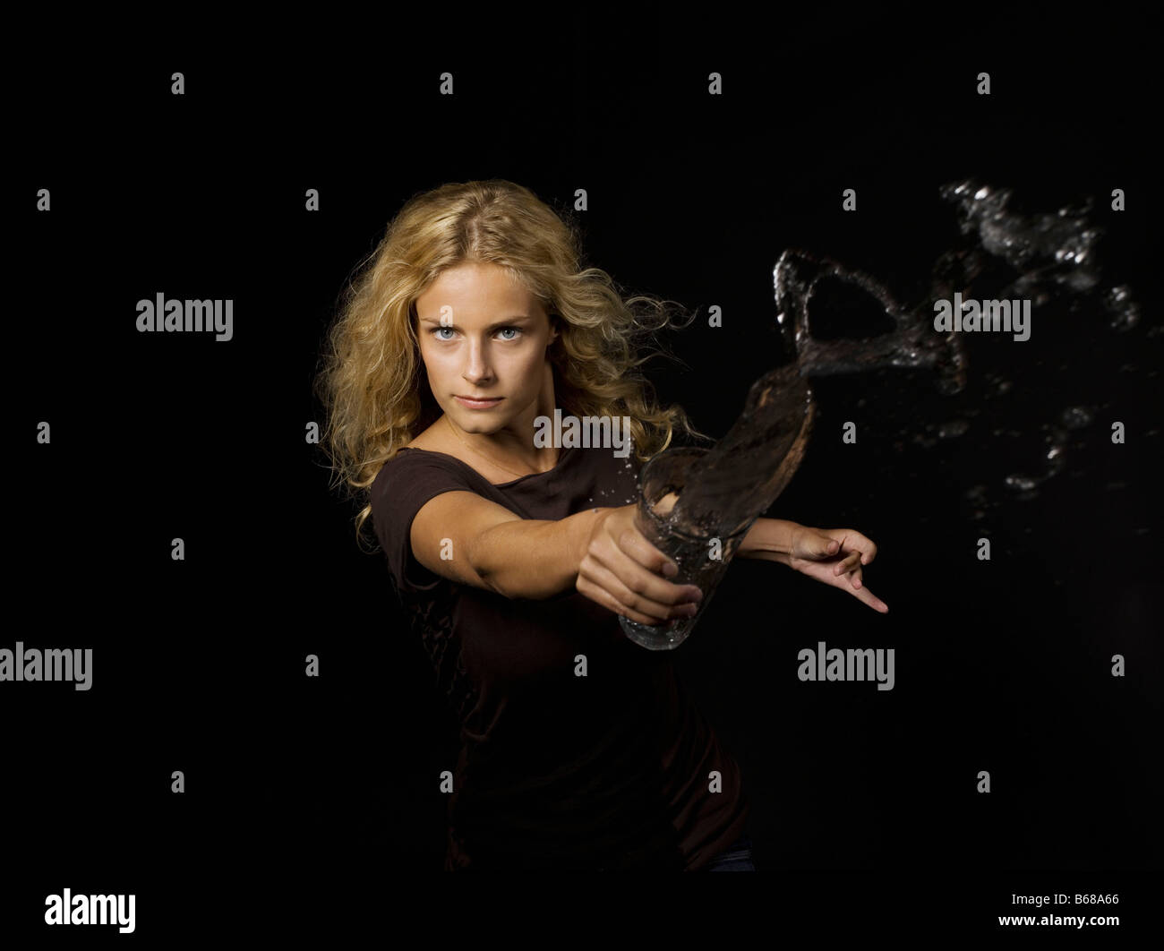 Woman throwing water from a glass Stock Photo - Alamy