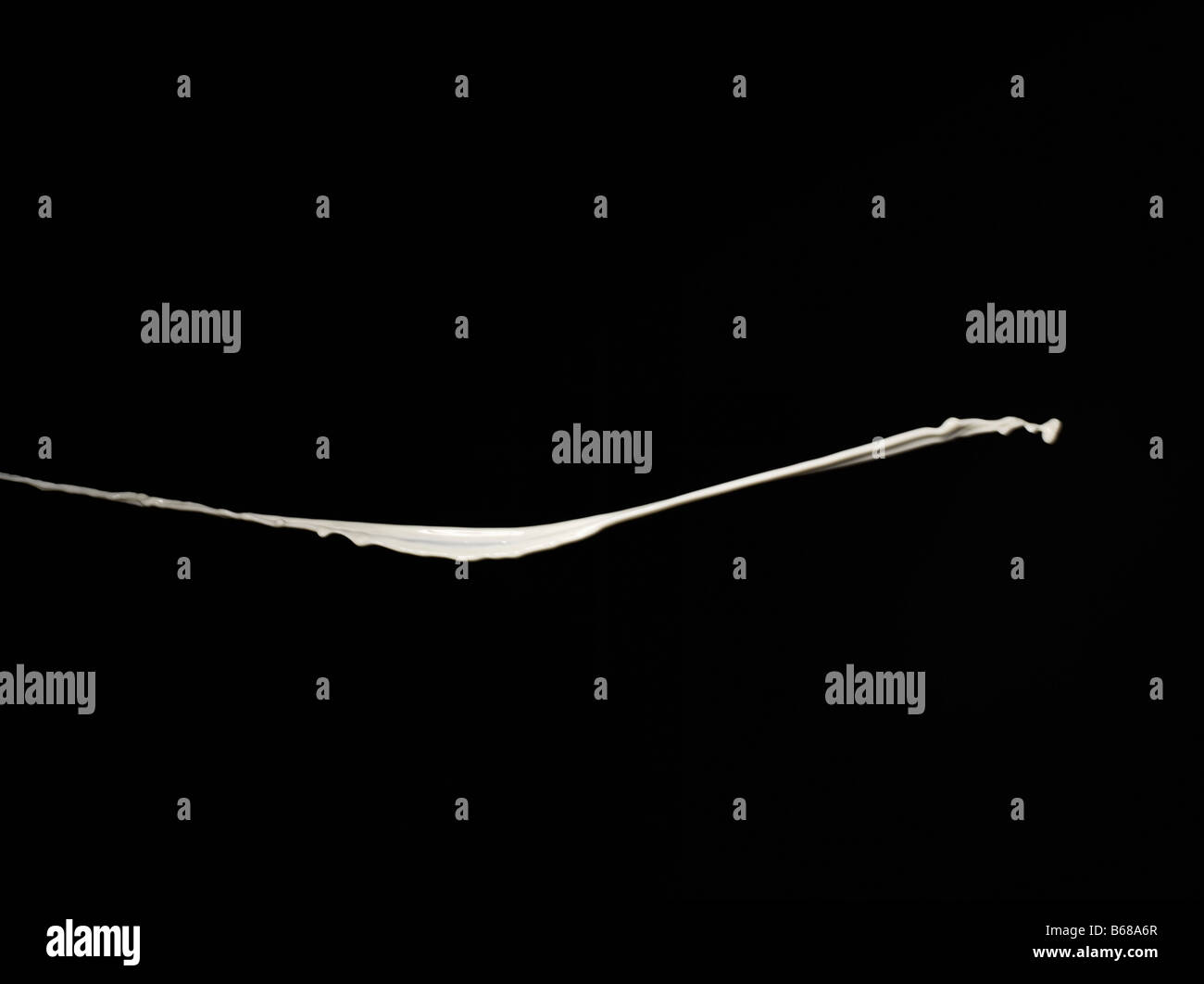 White liquid falling, slow motion Stock Photo - Alamy