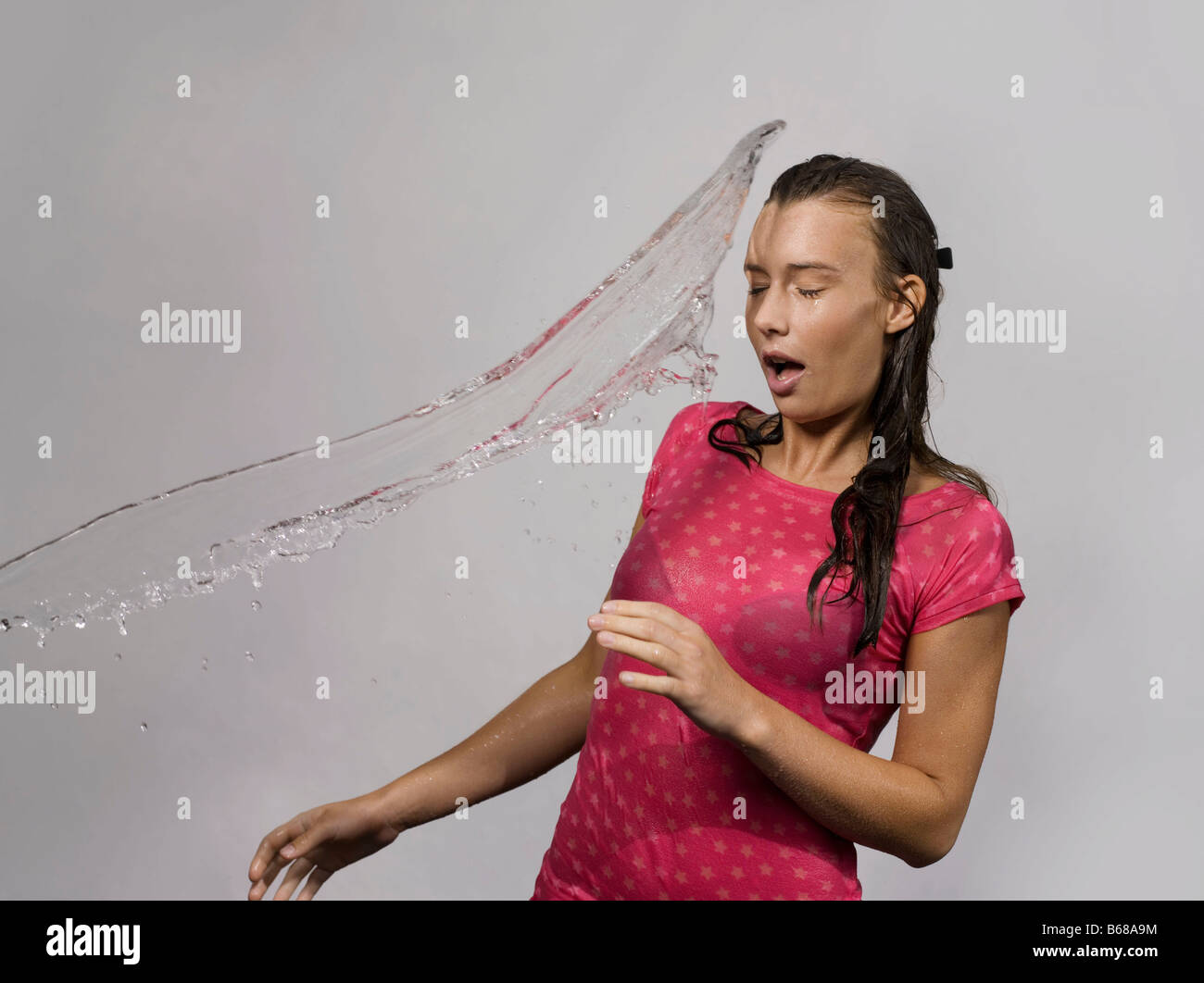 Young woman being splashed with water hi-res stock photography and ...